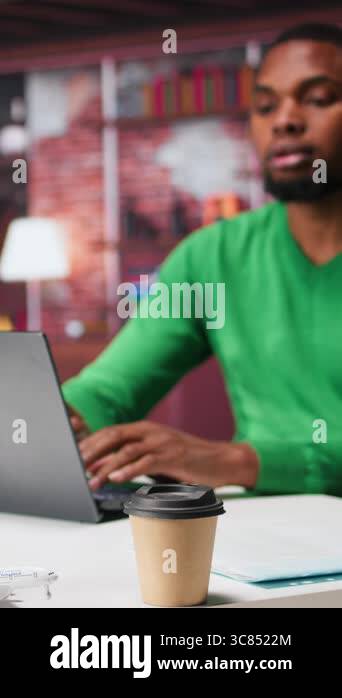Vertical Video African american employee seated at home office using ...
