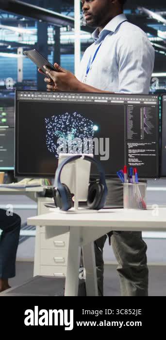 Vertical video Data center technician using tablet to do node tree ...
