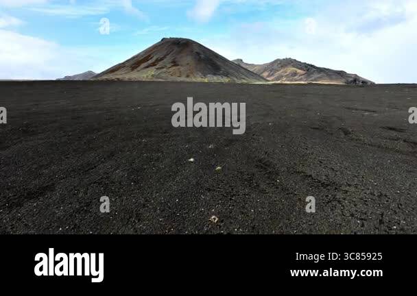 Black volcanic desert, drone flight over black sand, old extinct ...