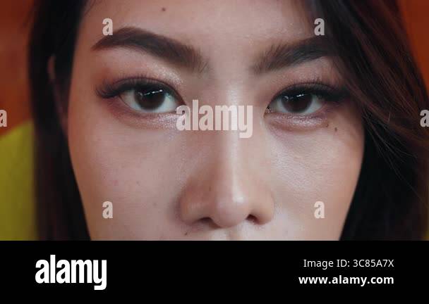 Closeup portrait of young Asian transwoman with extended eyelashes ...