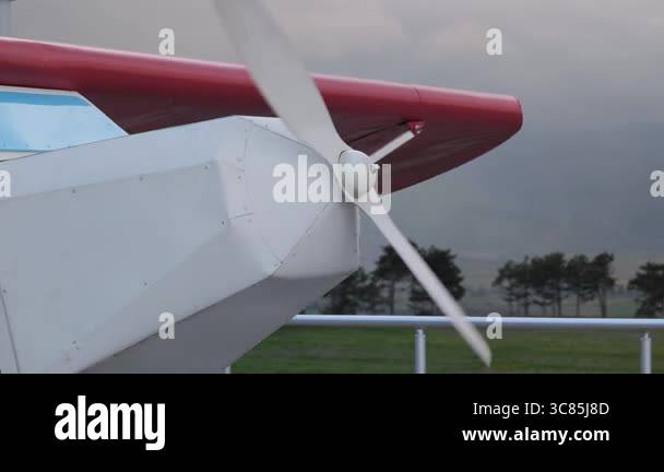Close up view of a white propeller spinning on a red and white light ...