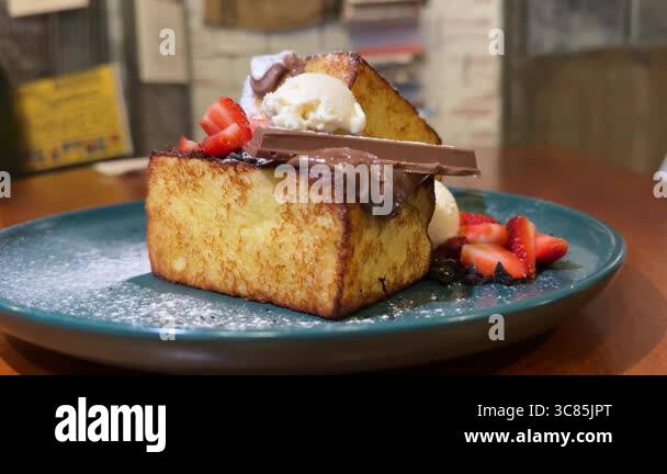 appetizing French toast stands in a chic restaurant on a blue plate ...
