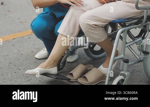 disabled woman in a wheelchair holding her foot Stock Video Footage - Alamy