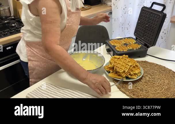 Chef taking out freshly made waffles from waffle iron Stock Video ...