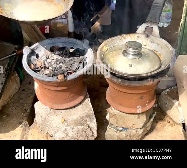 Traditional cooking method with a clay stove. Kerak Telor. Traditional ...
