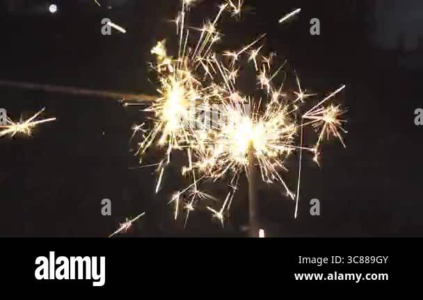 Holding burning sparkler in hands. Festive mood. sparkler in black ...