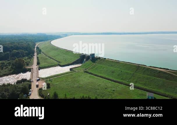 Aerial view of large dam discharging water into channel, managing water ...