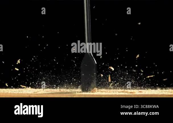 A carpenter drills a hole in a wooden product. Filmed on a high-speed ...