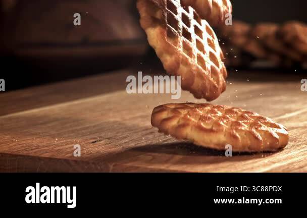 Cookies fall on a wooden table. Filmed on a high-speed camera at 1000 ...