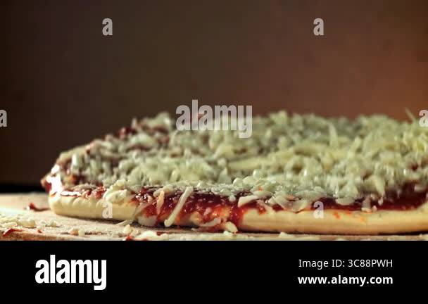 Making pizza. Pizza falls on the table. Filmed on a high-speed camera ...