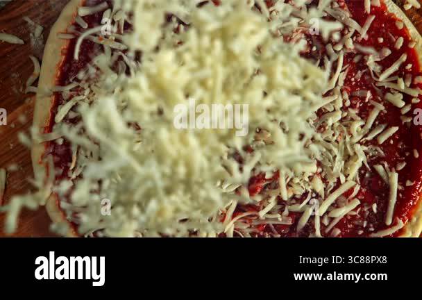 Making pizza. Mozzarella cheese falls on pizza. Filmed on a high-speed ...