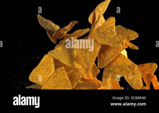 Corn chips fly up and fall down. Filmed on a high-speed camera at 1000 ...