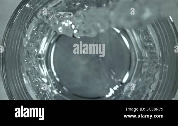 Water is poured into a glass. Filmed on a high-speed camera at 1000 fps ...