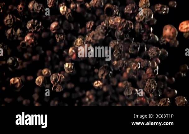 Black pepper flies up and falls down. Filmed on a high-speed camera at ...