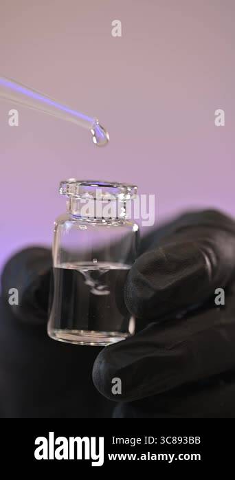 A detailed closeup image captures a lab worker skillfully using a ...