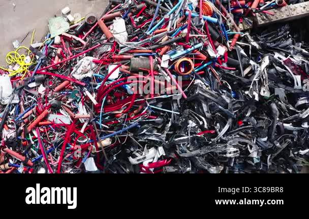 Close-up aerial view of a colorful, tangled pile of discarded cables ...