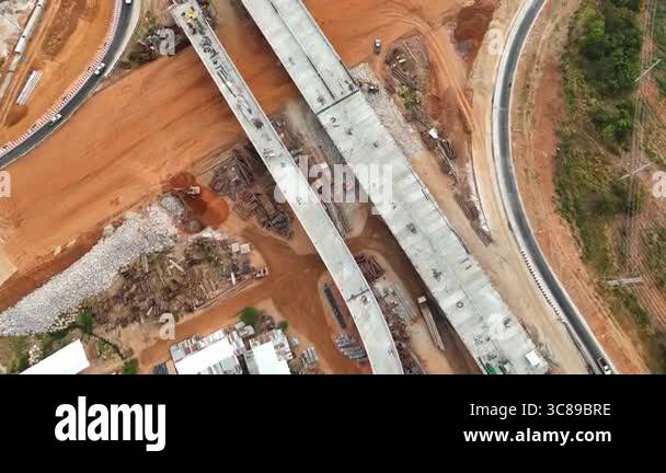 Drone footage Aerial view of highway overpass construction site with ...