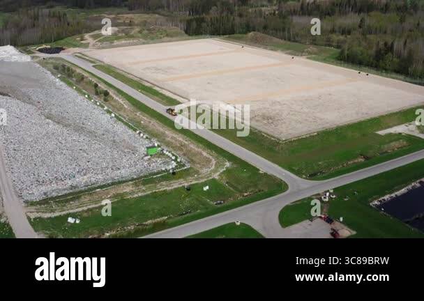 Kudums, Latvia - April 28, 2025 - Aerial view of a landfill site with ...