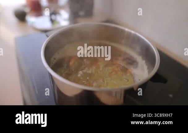 A close-up view of ingredients boiling in a pot, showcasing the cooking ...