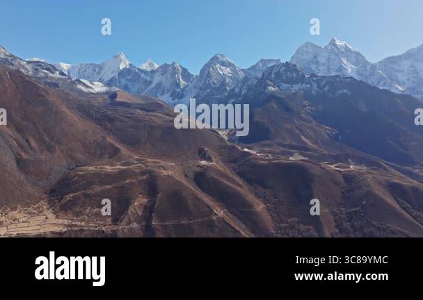 Aerial panorama revealing Mount Everests massive peaks piercing through ...