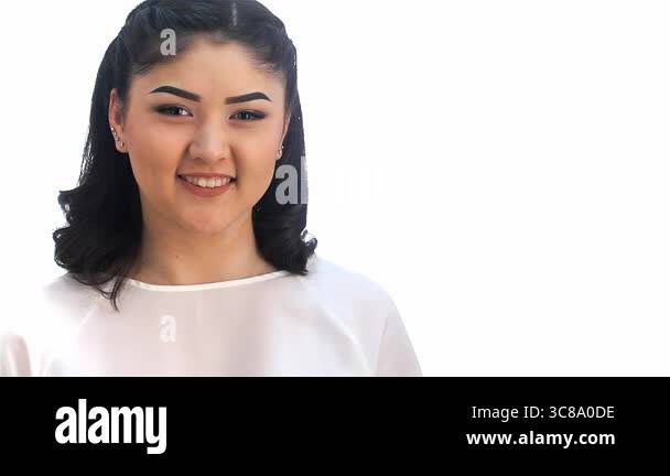 A radiant young Asian girl beams with a perfect toothy smile as she ...