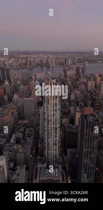 Vertical panorama captures New York City skyline at dusk, featuring the ...