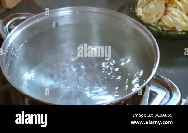 Boiling water bubbling in a pot. Slow motion video 100fps. High quality ...