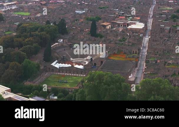 Aerial view of Pompeii in Italy with a slow pan over ruins, streets ...