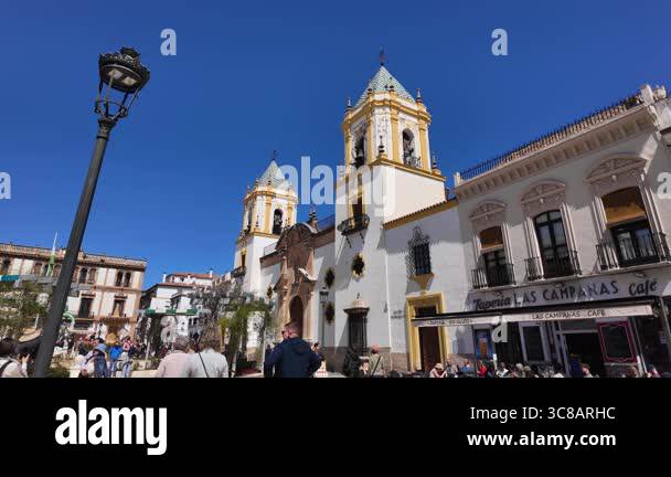 Tourists walking in Plaza Duquesa de Parcent with Santa Maria la Mayor ...
