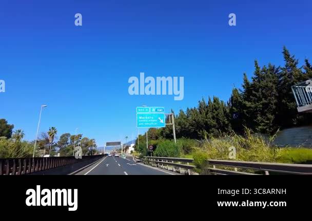 Highway approaching Marbella in Andalusia, Spain, featuring road signs ...