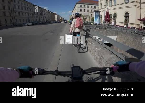 April 29, 2025. Munich, Germany. POV from bicycle in Munich city center ...