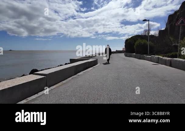 Relaxing walk on beach promenade with ocean in Europe Stock Video ...