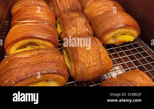 Golden layered pastry on plate in natural light With puffed edges and a ...