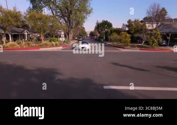 Aerial footage capturing a white car driving through a scenic ...