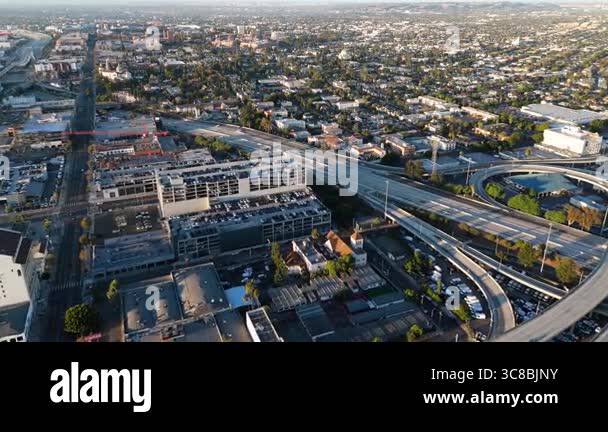 An aerial view captures a modern freeway interchange and urban ...