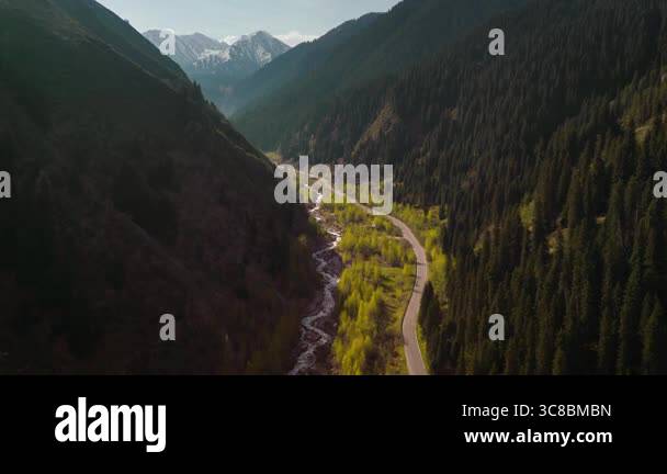 Beautiful aerial drone scenery of the river in the mountains and green ...