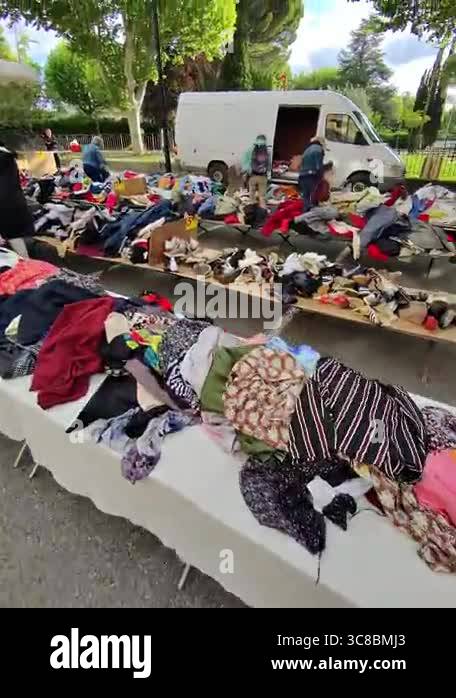 Second-hand clothing for sale at a market stall in the south of France ...
