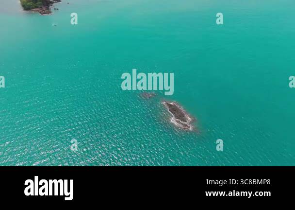 Turquoise waters gently enveloping rocky island landscape, revealing ...