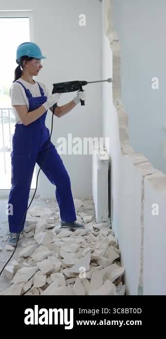 Female construction worker wearing safety glasses and a hardhat ...