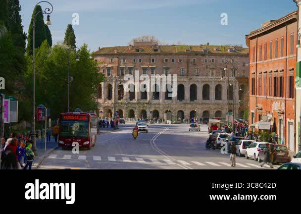 Rome, Italy, 29.04.2025: View of the Colosseum through an old street in ...