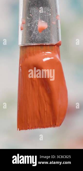 Vertical video. Paintbrush with Red Paint Bending on Finger in Close-Up ...