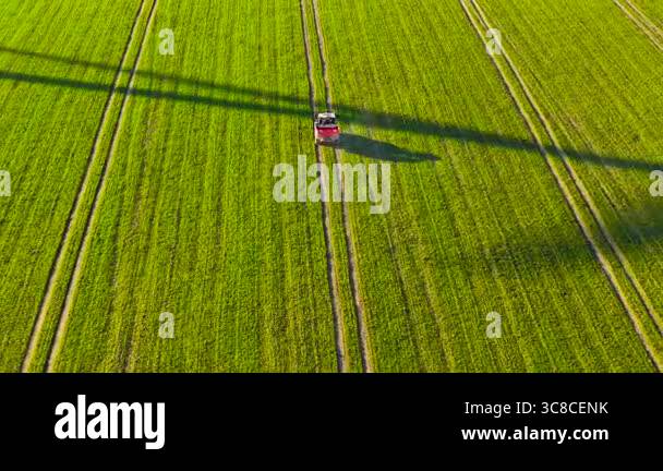 Tractor spraying chemical granules on agricultural field. Farming ...