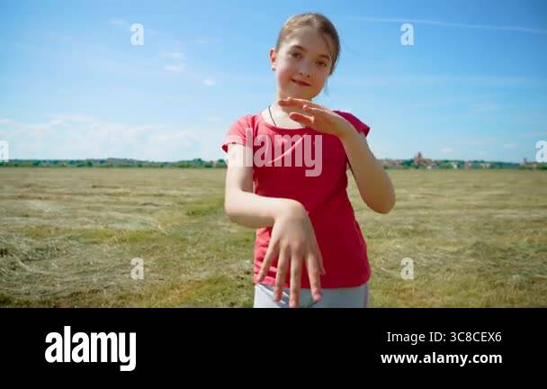 Joyful teenage girl playfully dancing, mimicking kitten paw movements ...