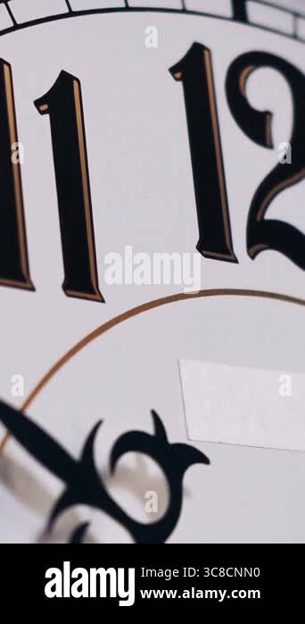 Extreme close-up timelapse in vertical format shows ornate black hands ...