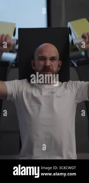 Man lifting weights and smiling at gym Stock Video Footage - Alamy