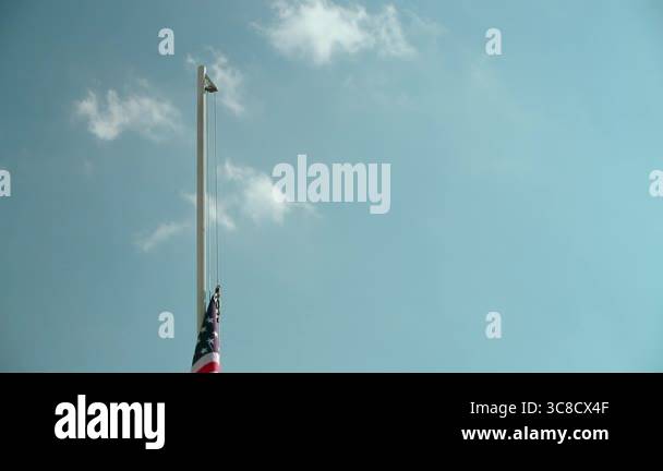 Hoist USA flag with blue sky Stock Video Footage - Alamy