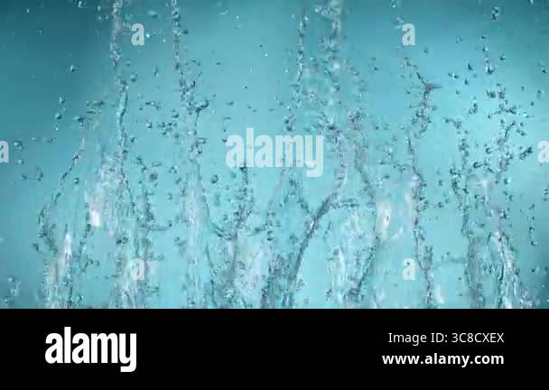 Slow motion of splashing water on light blue background , filmed on ...