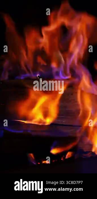 Roaring flames in modern fireplace. Glowing fire in a huge stone ...