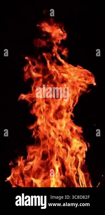Huge burning fire with tiny sparkles flying up quickly. Flame of big ...