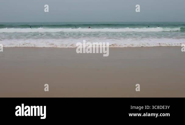 Atmospheric seascape with misty grey skies over turquoise ocean waves ...